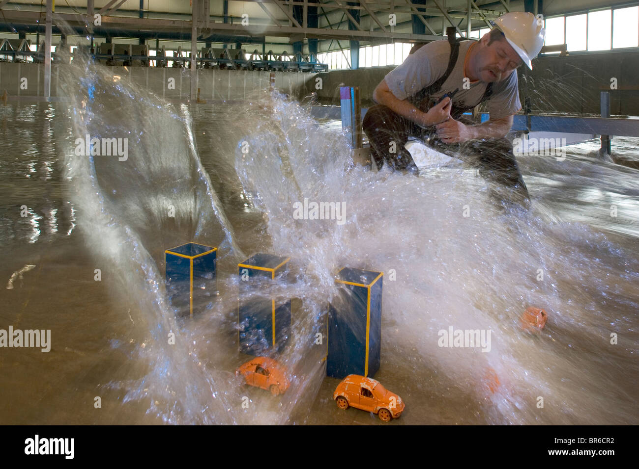 A Tsunami simulation wave topples model buildings Stock Photo - Alamy