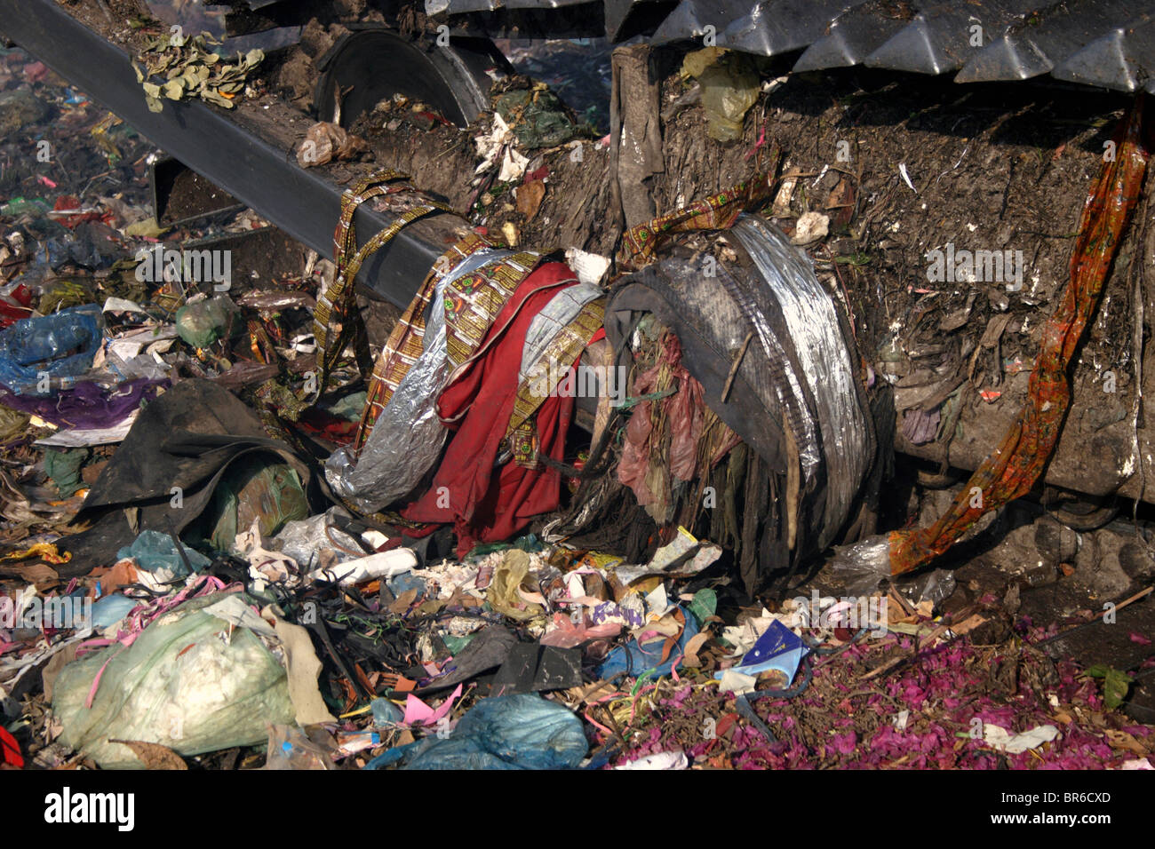 A tractor is clogged with garbage at The Stung Meanchey Landfill in ...