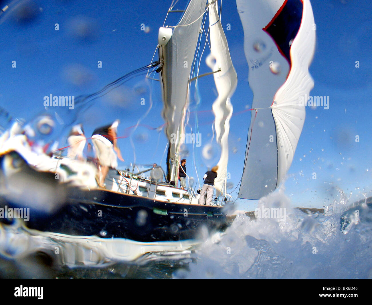 Water-splashed wide angle action image of a racing sailboat Stock Photo ...