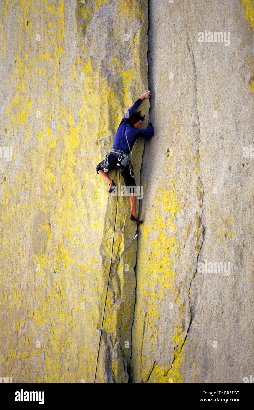A male rock climber jamming his hands in a crack on a cliff face Stock ...