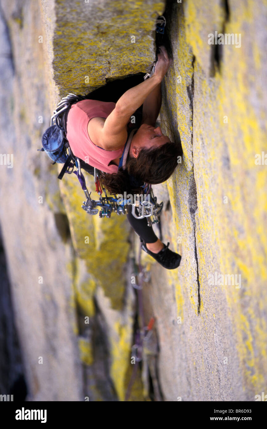 A female rock climberplaces a camming device while climbing Stock Photo ...