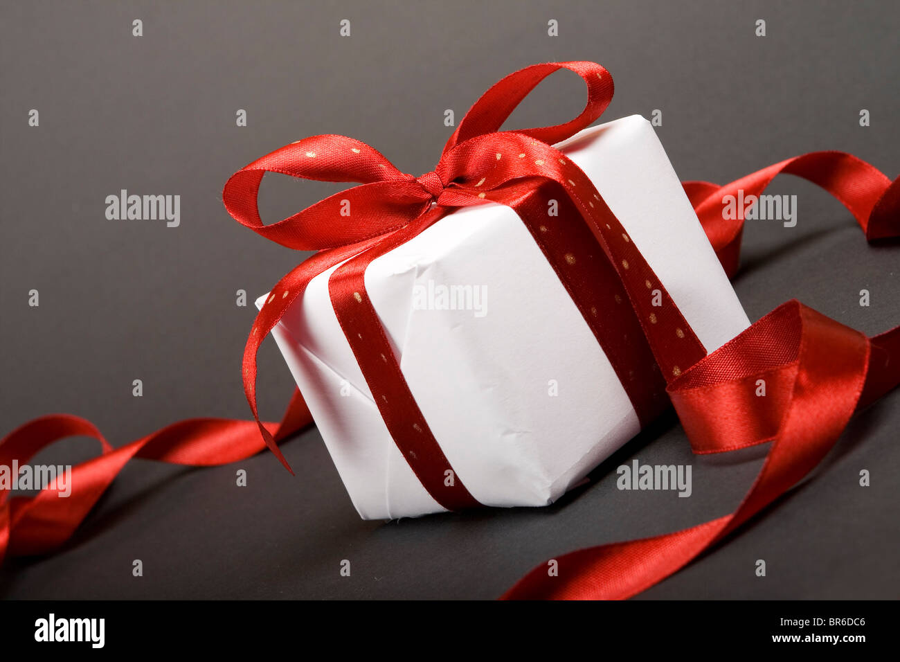 Gift with red ribbon Stock Photo - Alamy