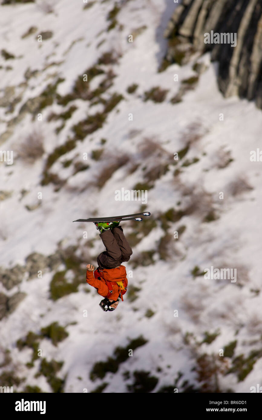 A male Ski BASE jumper jumps off an 800 foot granite cliff in the ...
