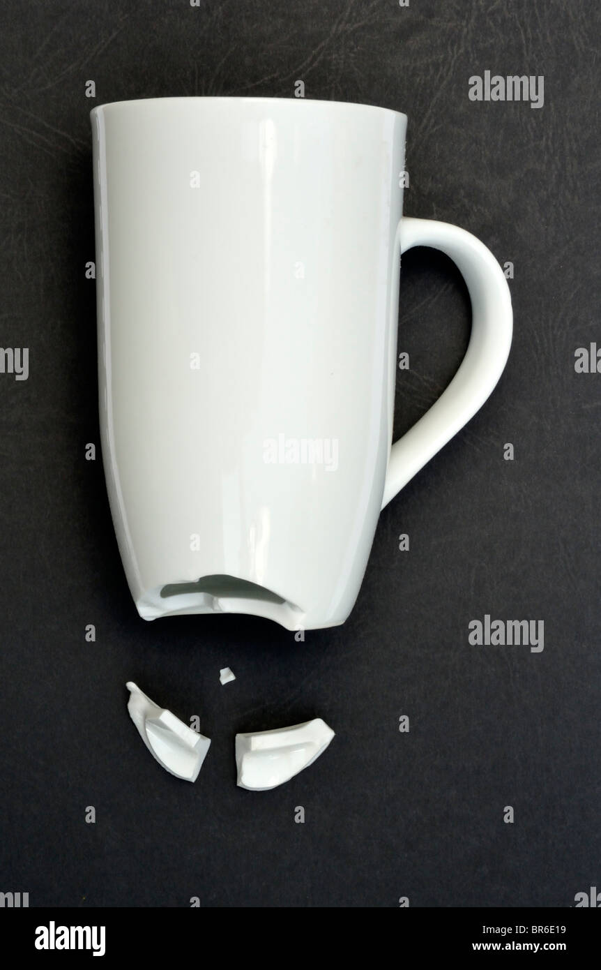 Broken white drinking mug Stock Photo - Alamy