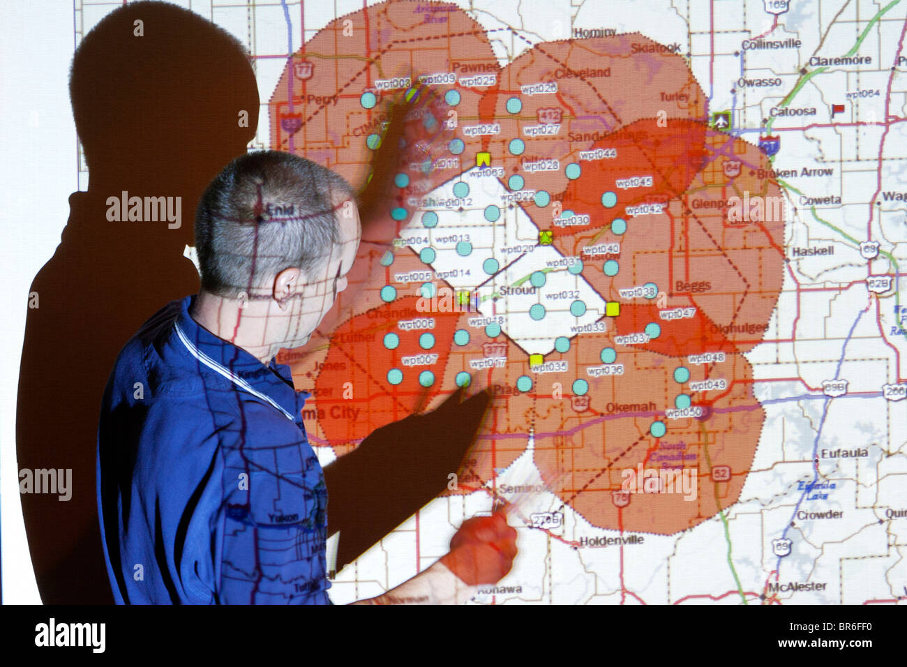 A Vortex 2 scientist points at the planned radar deployment grid before ...