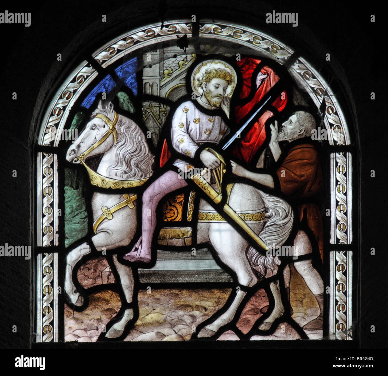 A stained glass window depicting St Martin of Tours sharing his cloak ...