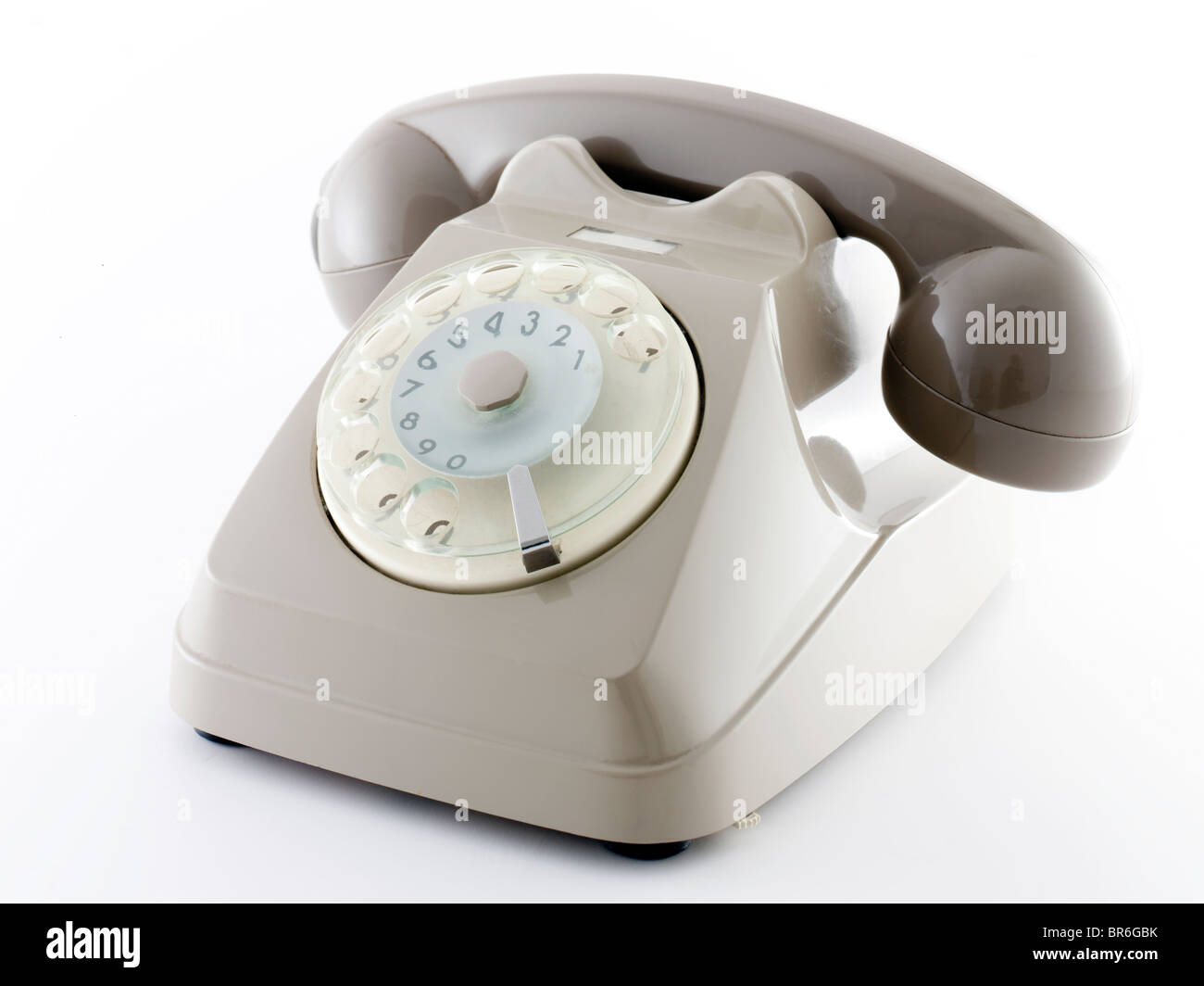 old rotating dial telephon over a white background Stock Photo - Alamy