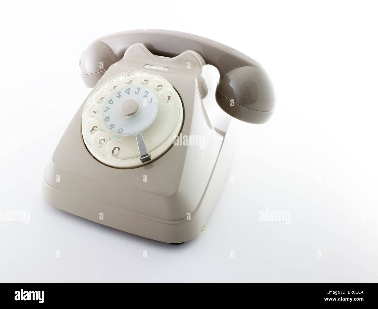 old rotating dial telephon over a white background Stock Photo - Alamy
