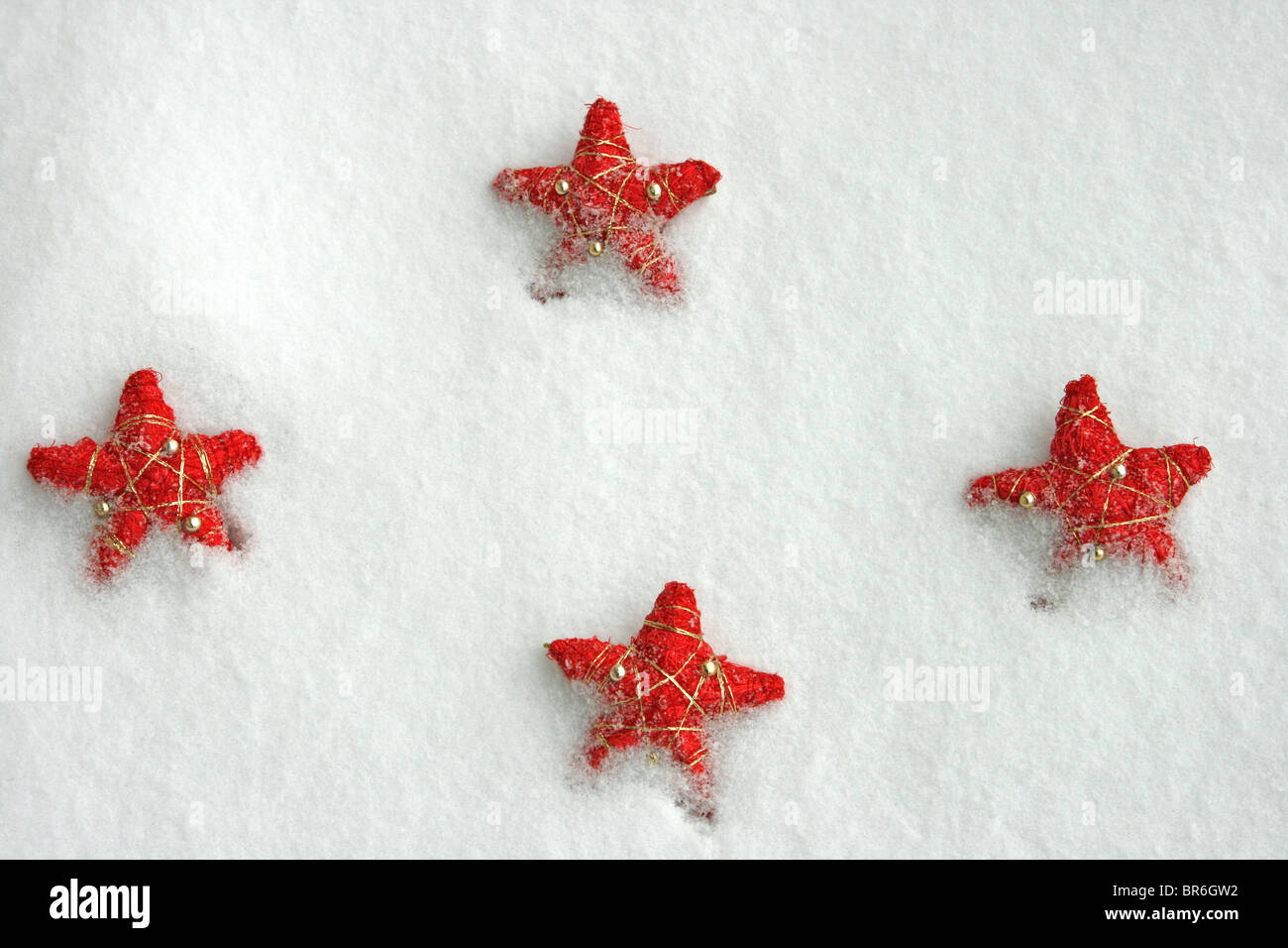 Red Christmas stars on the snow Stock Photo - Alamy