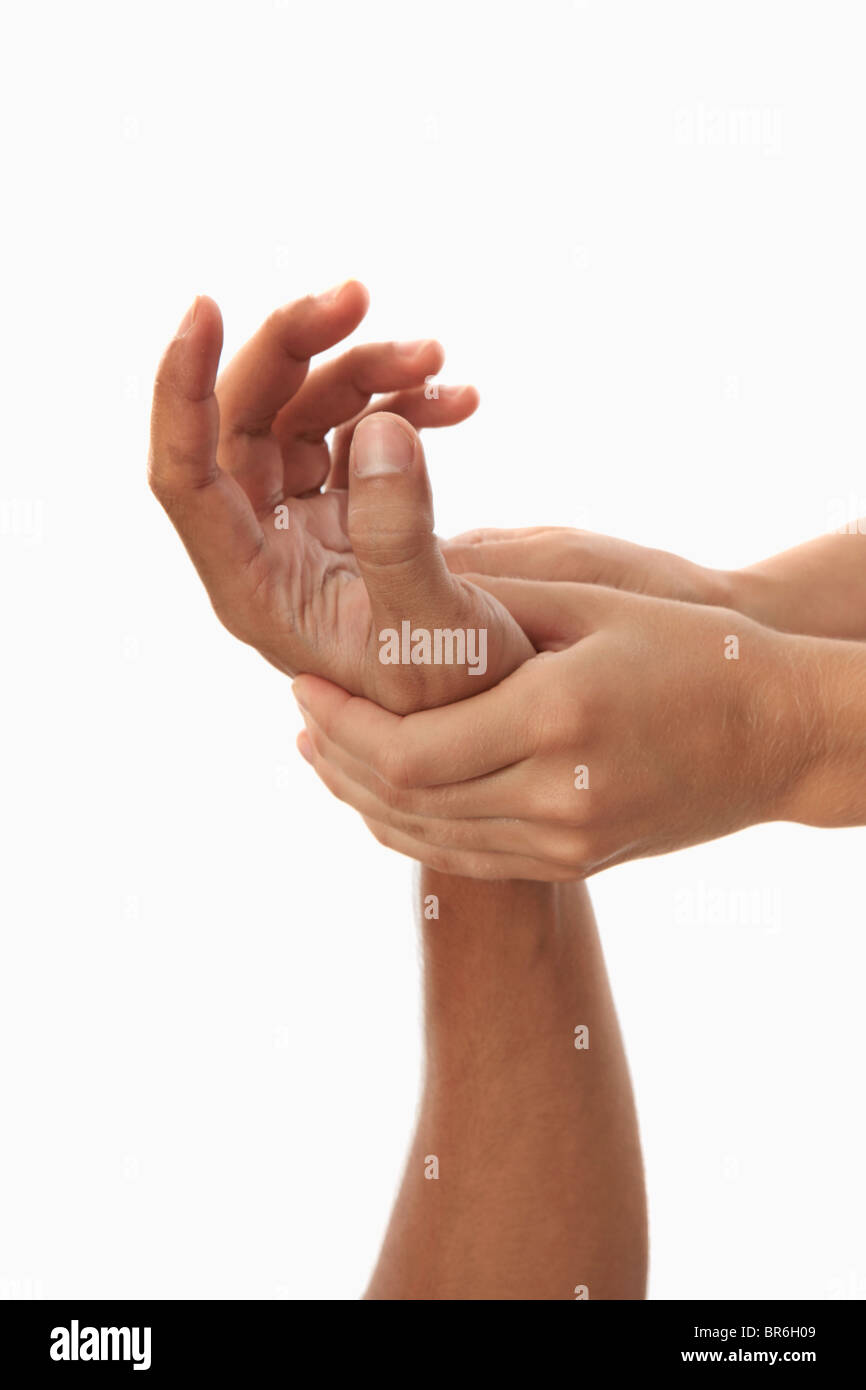 healing touch of a masseus's hands as she massages a young man Stock ...