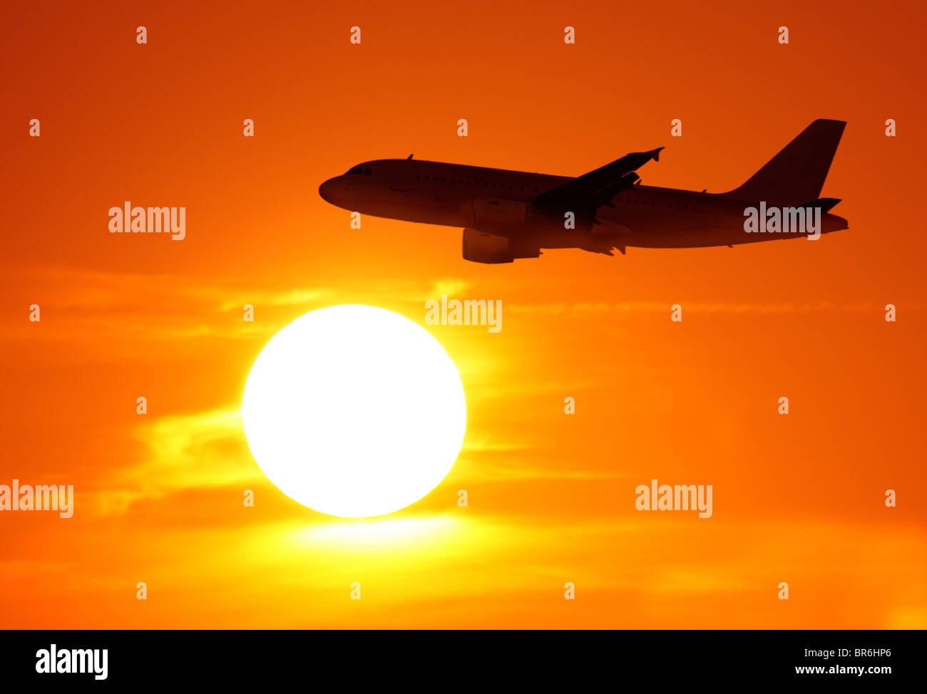 An airplane flying on a sunset in Spain Stock Photo - Alamy
