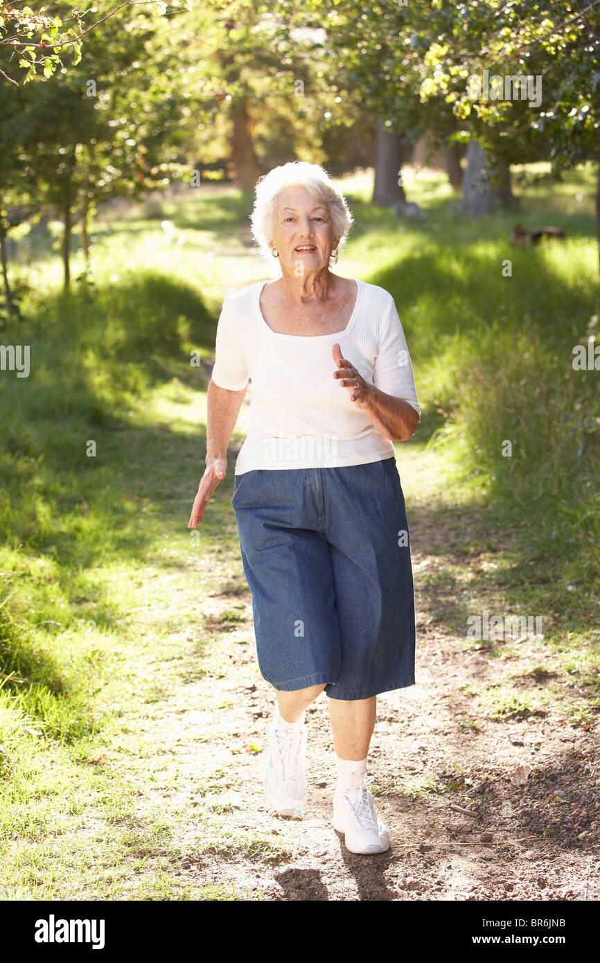 Senior Woman Jogging In Park Stock Photo - Alamy
