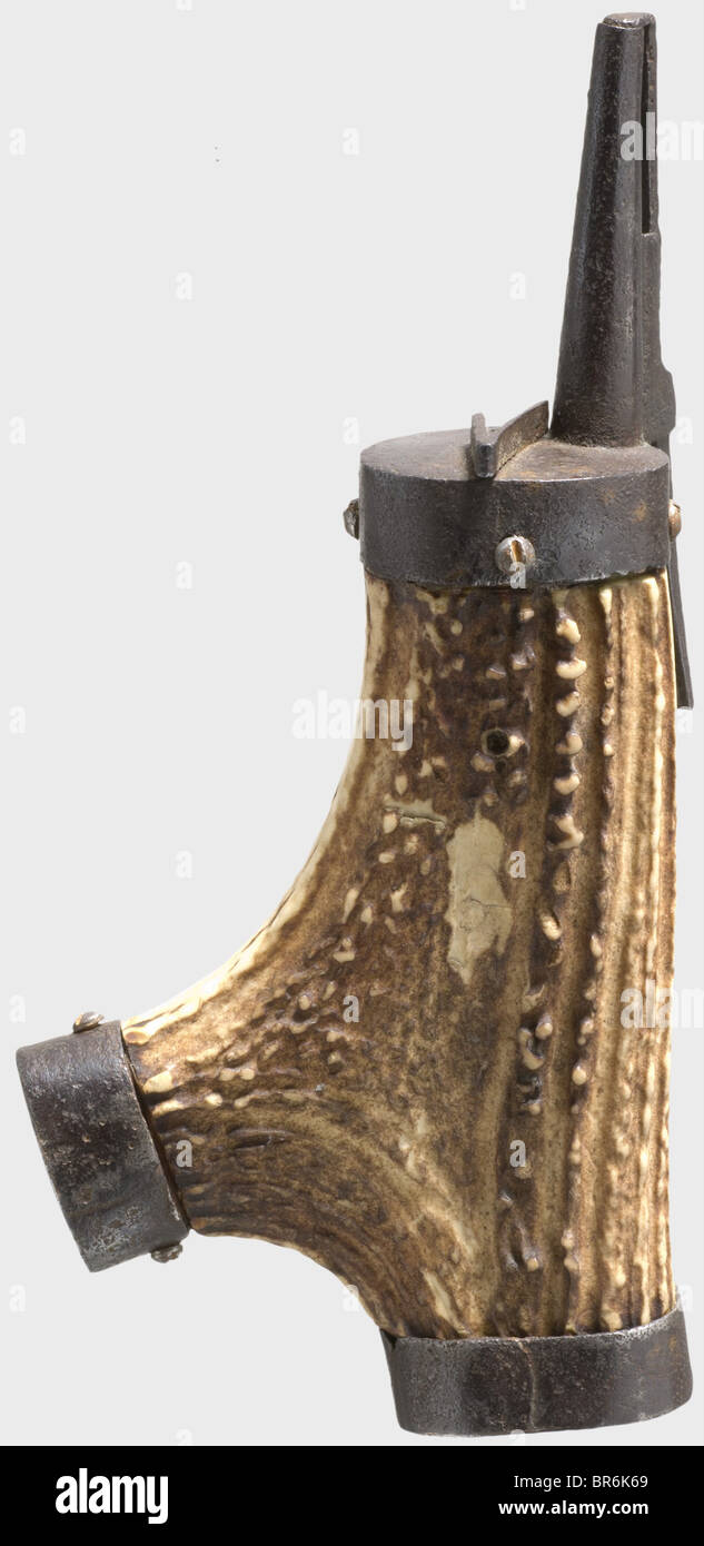 A carved German powder flask, 16th century. Made from a large antler ...