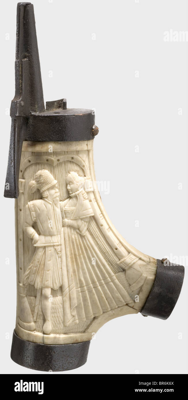 A carved German powder flask, 16th century. Made from a large antler ...