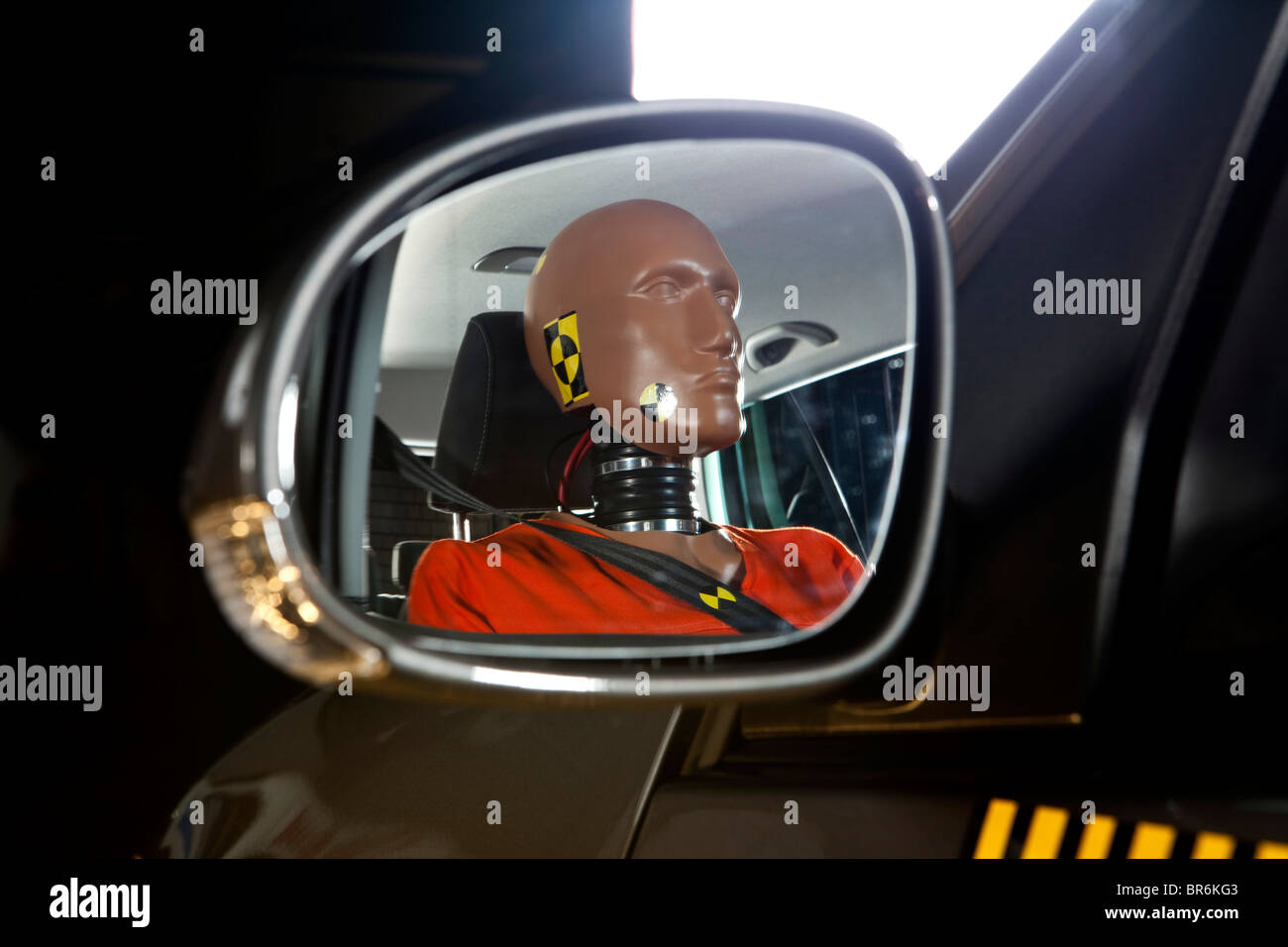 A crash test dummy reflected in a side-view mirror Stock Photo - Alamy