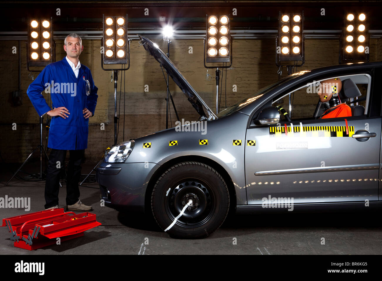 A technician standing next to a crash test car Stock Photo - Alamy