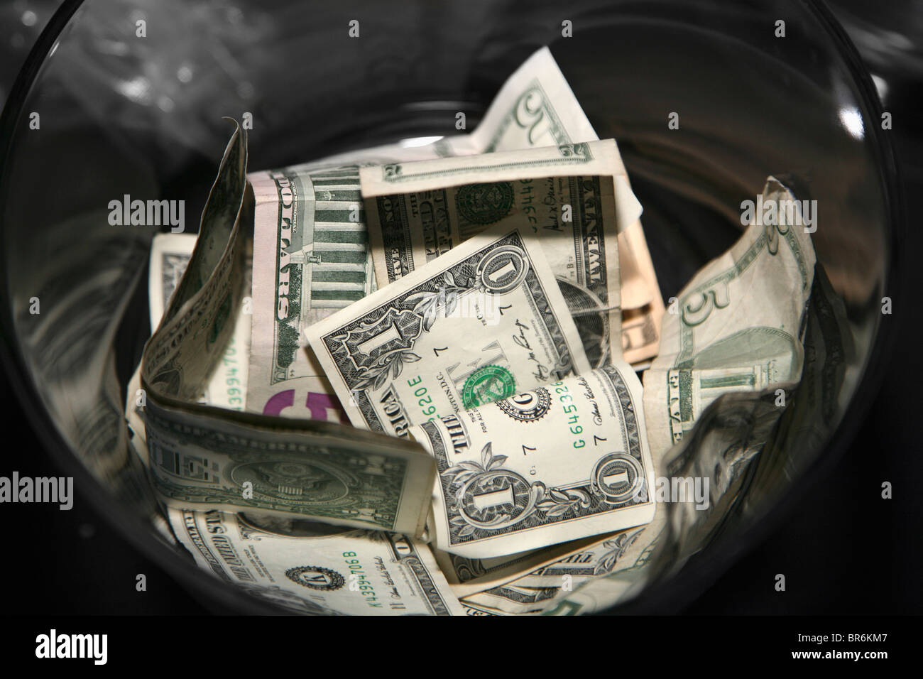US bank notes in a container Stock Photo - Alamy