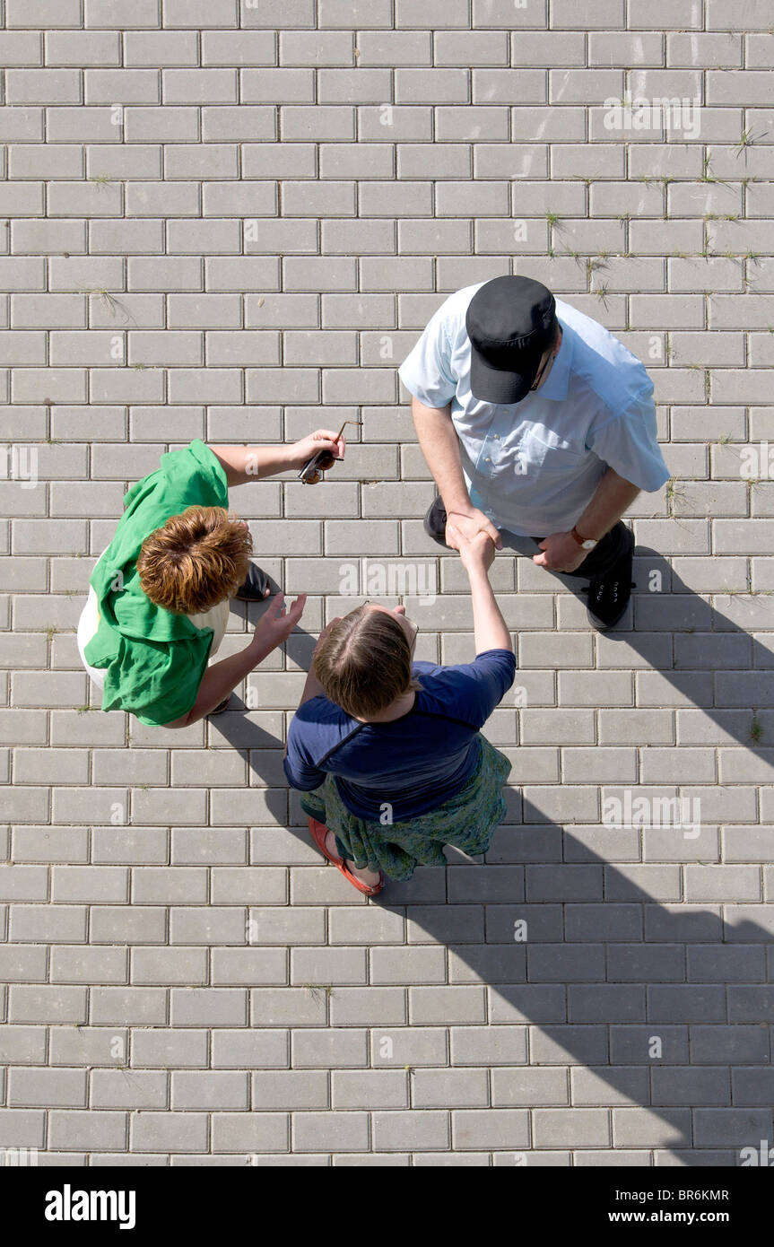 A man introducing a friend to another friend Stock Photo - Alamy