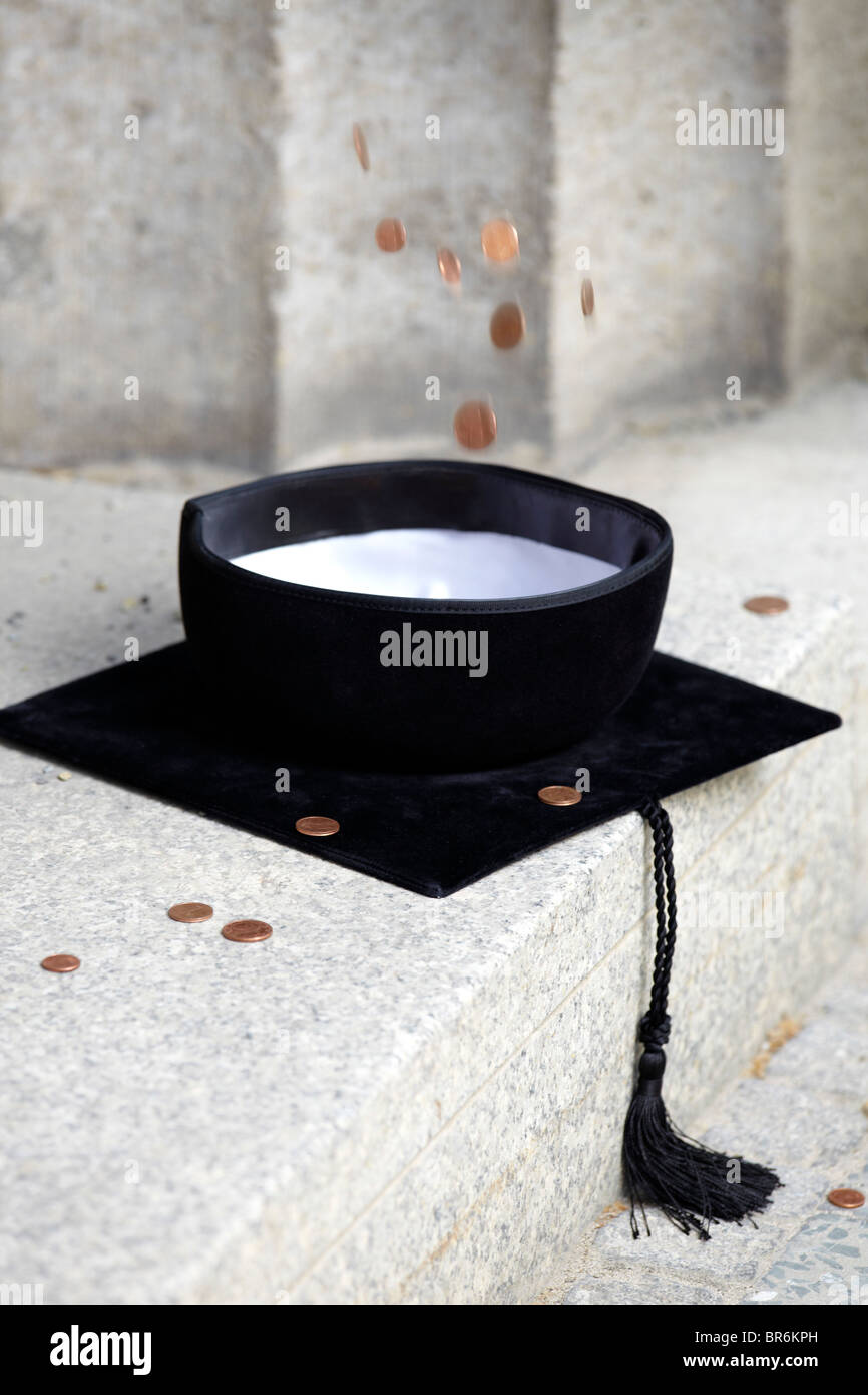 Copper coins falling into mortarboard Stock Photo - Alamy