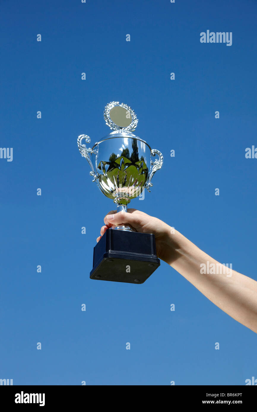 One hand raising trophy Stock Photo - Alamy