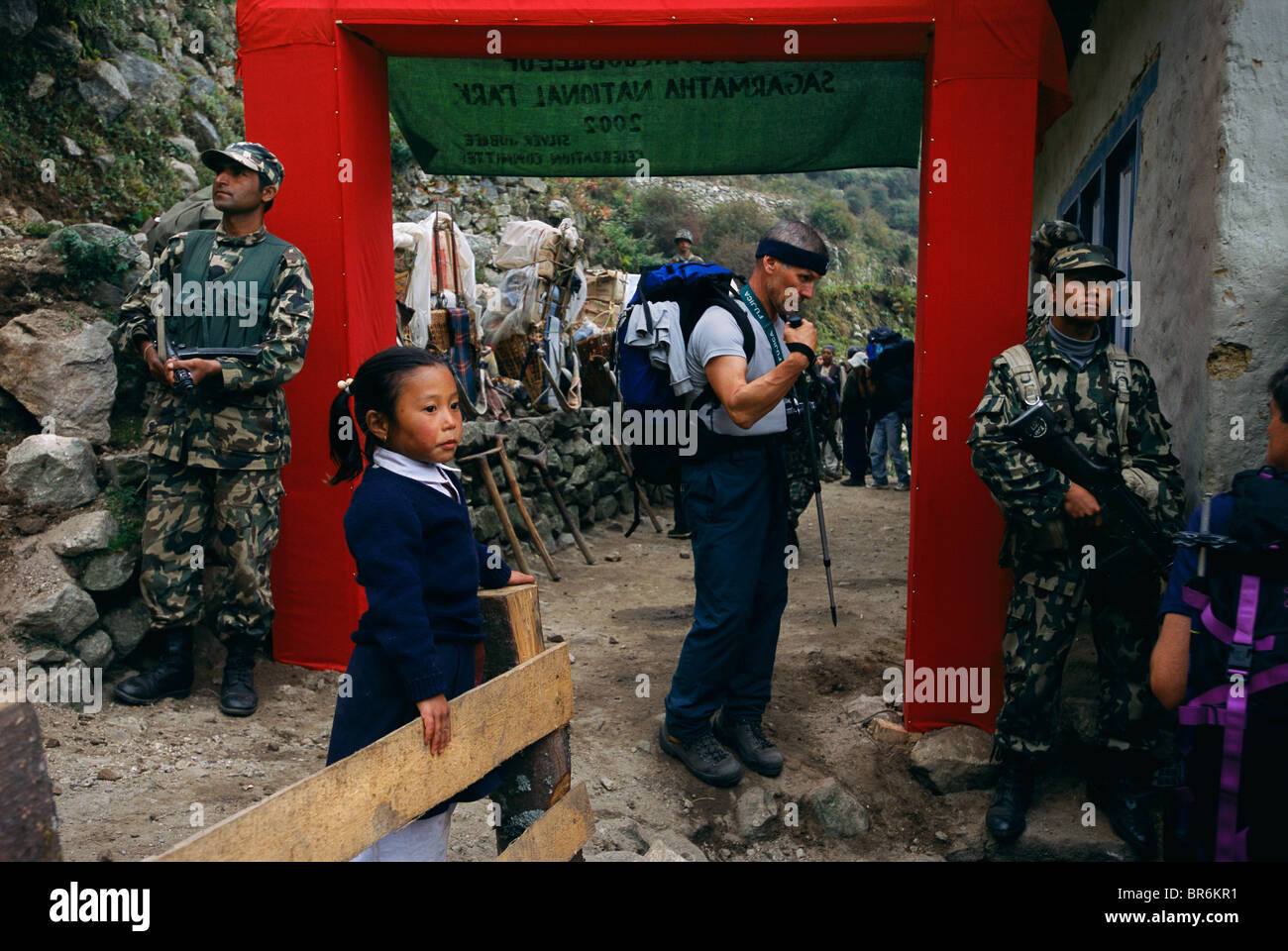 A European Climber awaits his Sherpa guide at the entrance to a temple ...