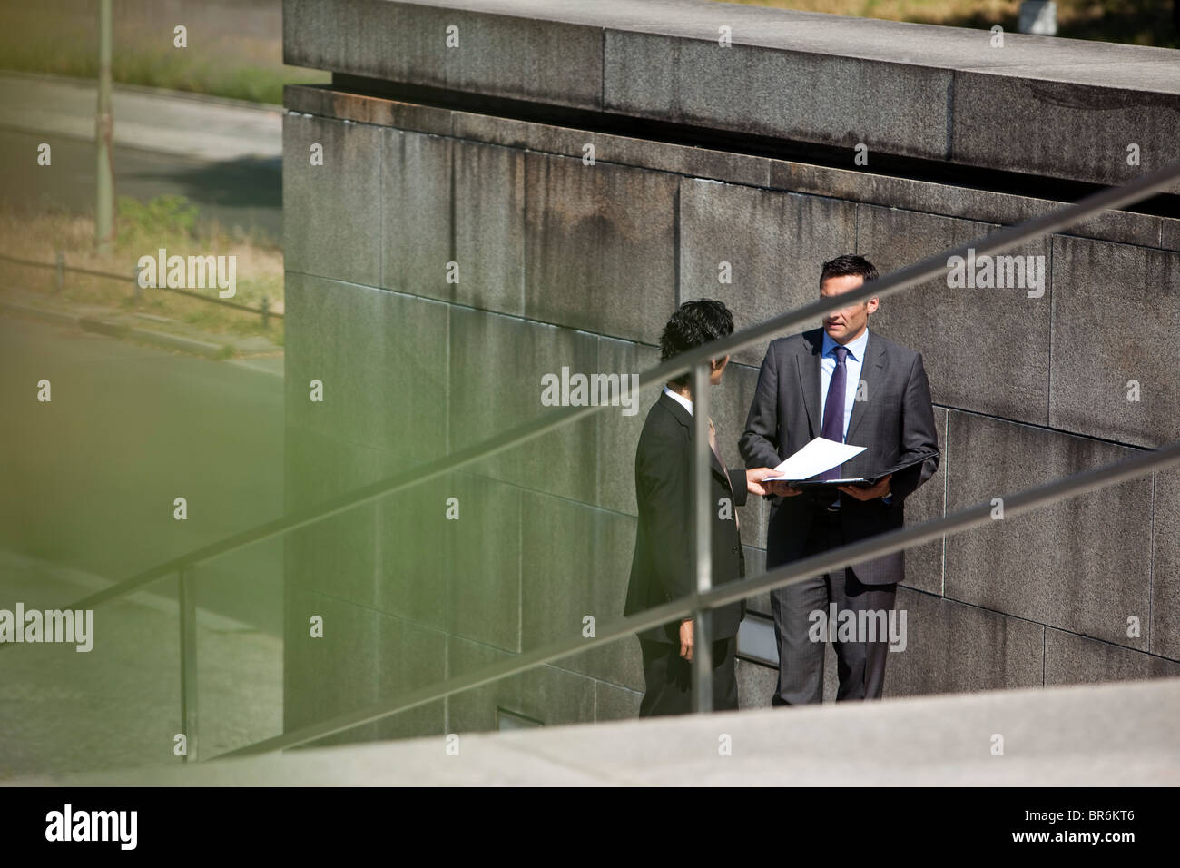 Two businessmen conducting suspicious business Stock Photo - Alamy