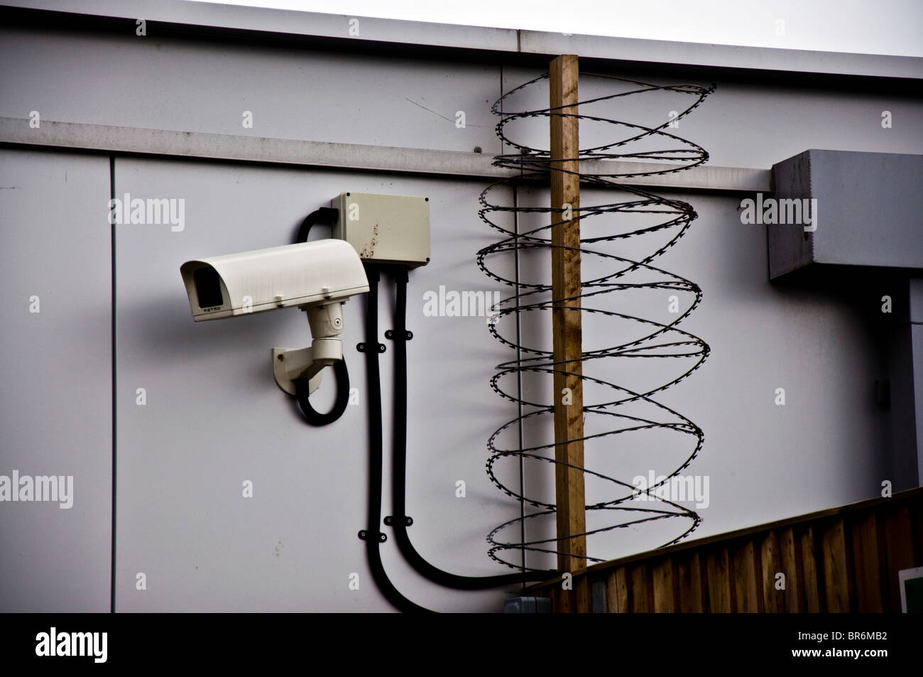 Security camera and razor wire Stock Photo - Alamy
