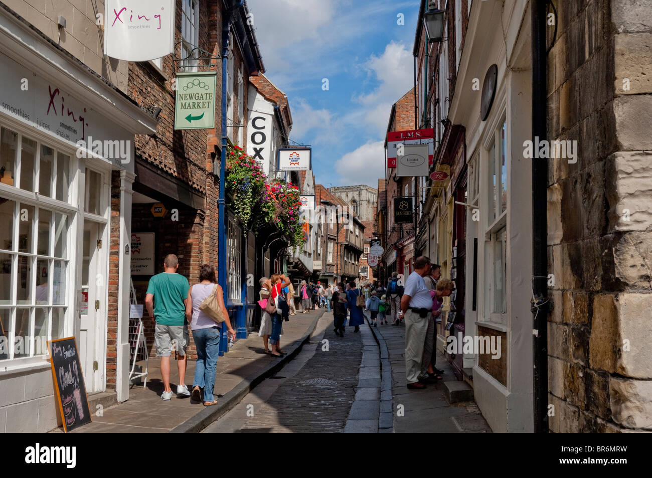 People tourists visitors walking along The Shambles in the city centre ...