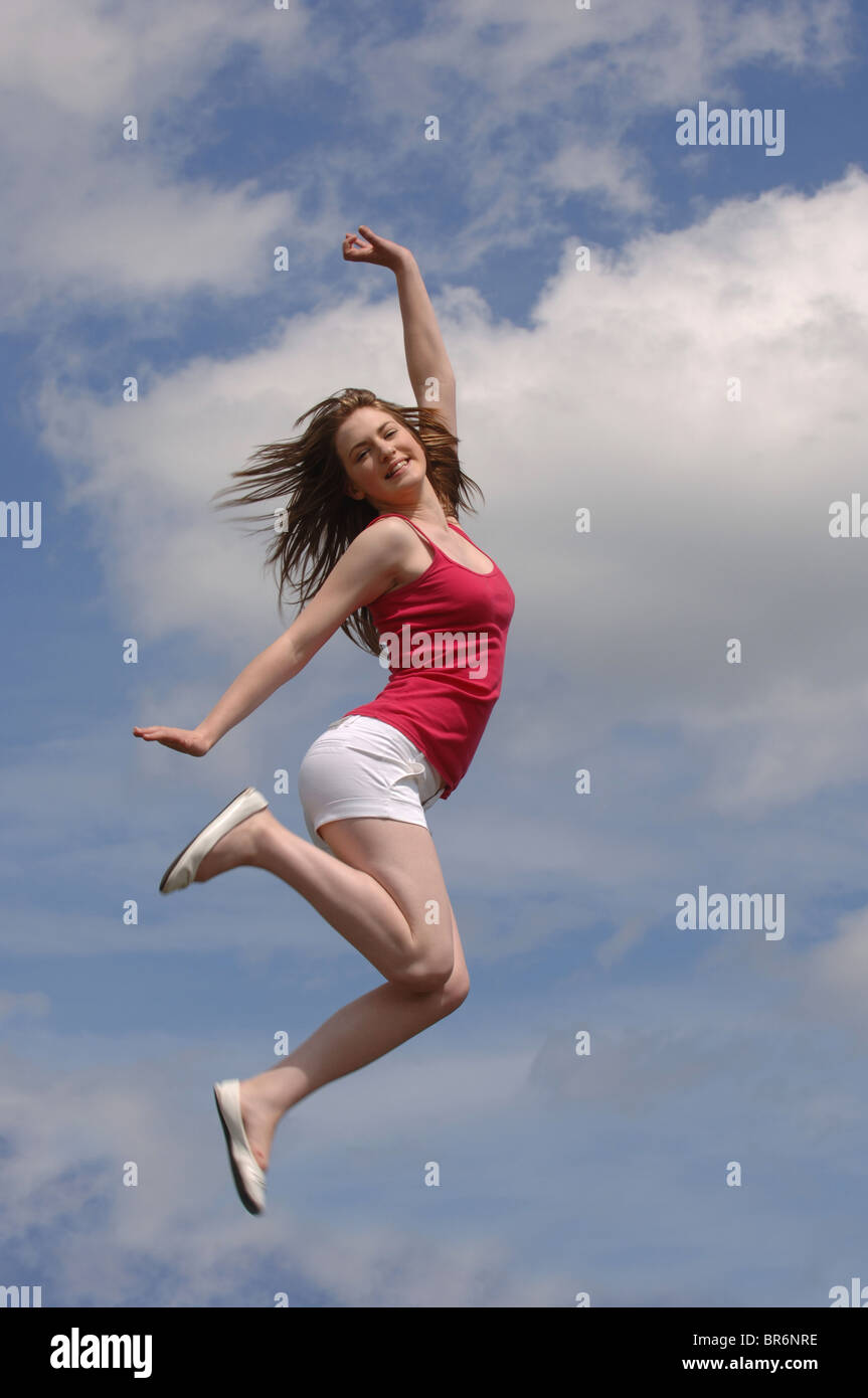 Attractive Teenager Jumping for Joy Stock Photo - Alamy