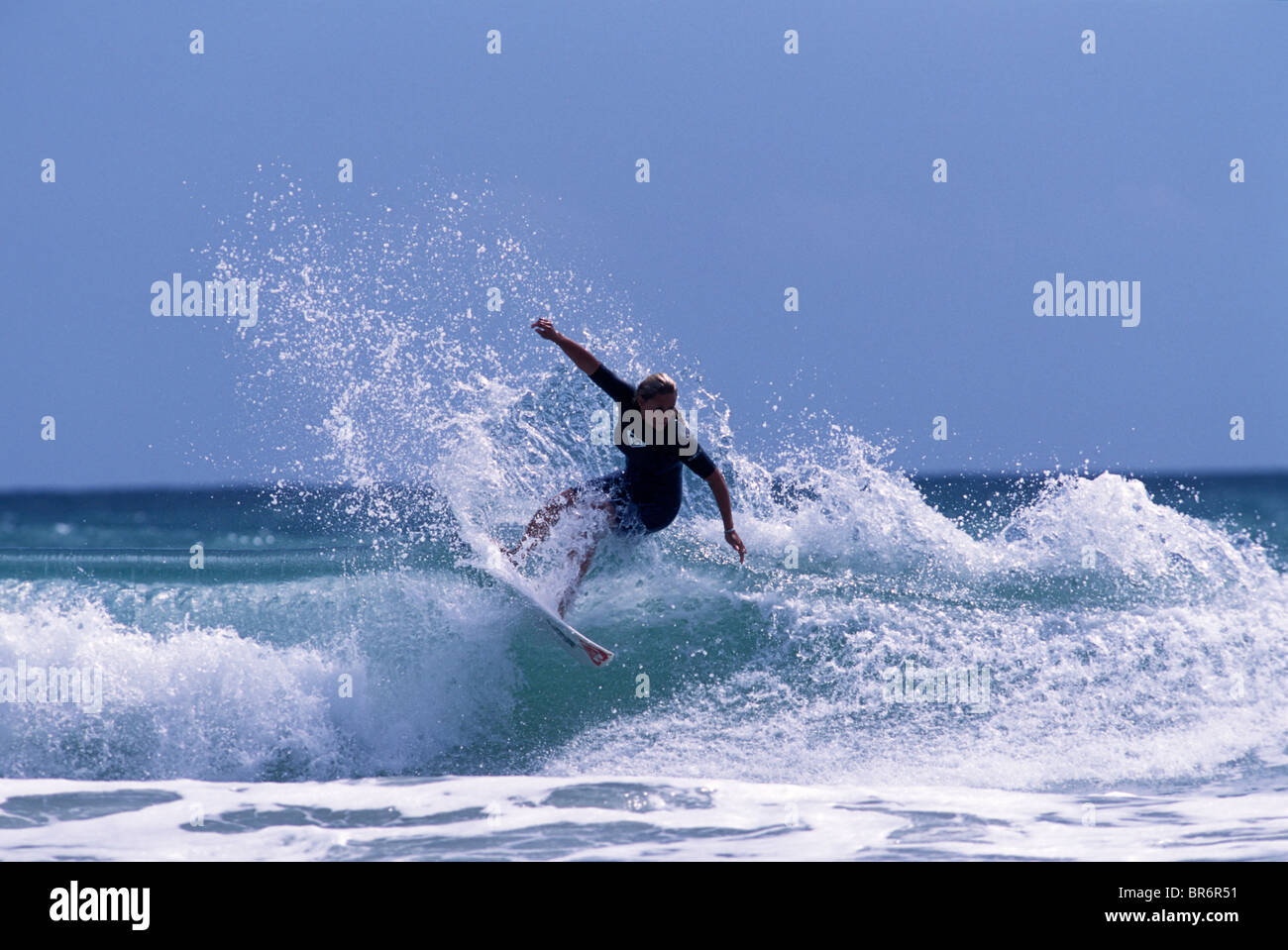 A female surfer surfing on a choppy coastline Stock Photo - Alamy