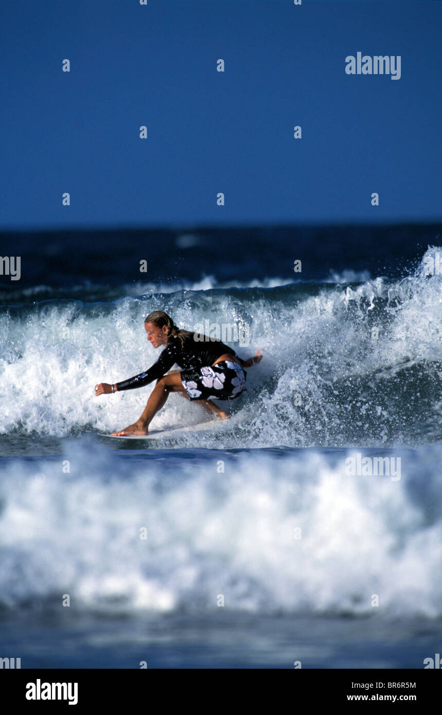 A female surfer surfing on a choppy coastline Stock Photo - Alamy