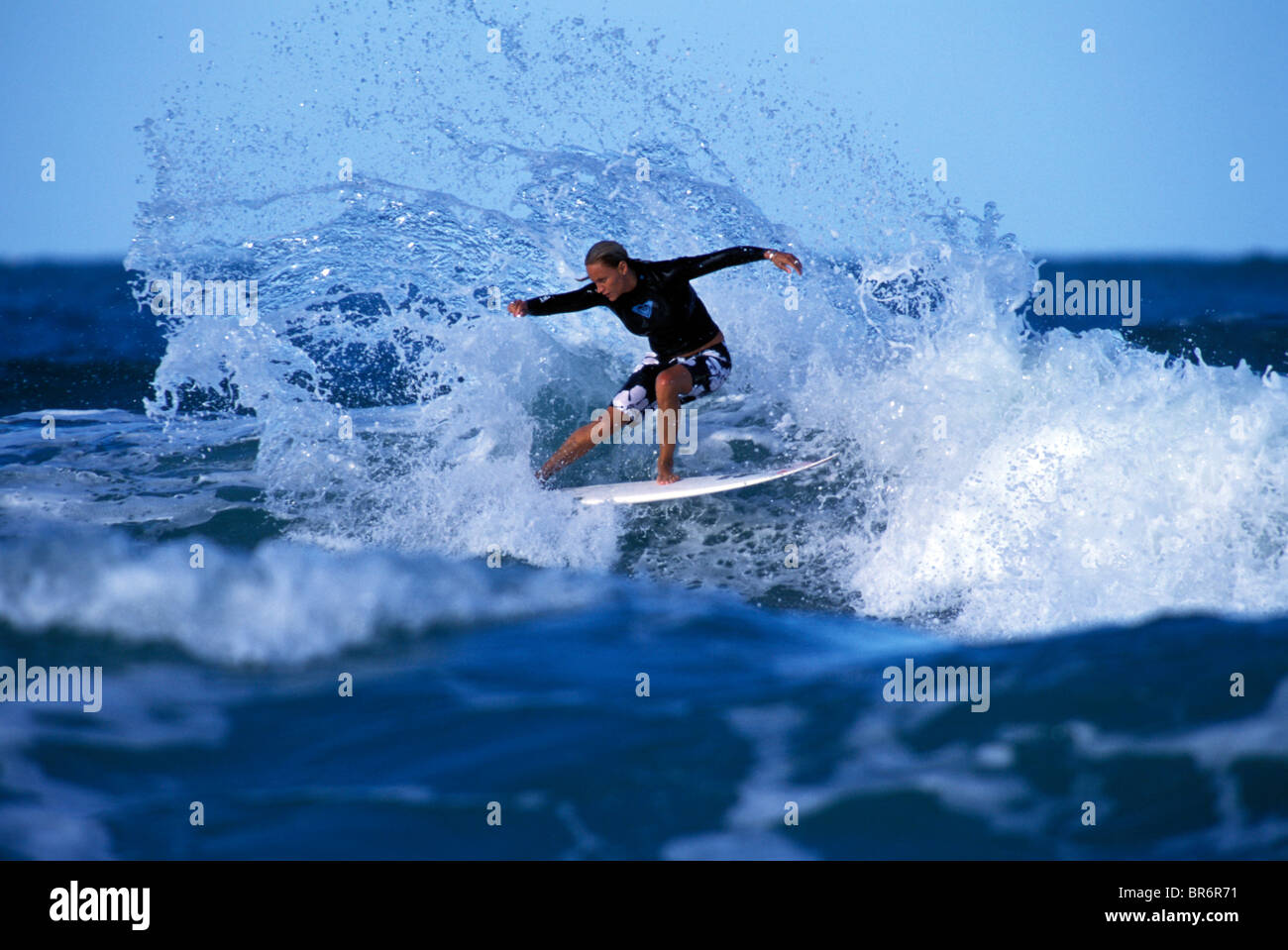 A female surfer surfing on a choppy coastline Stock Photo - Alamy