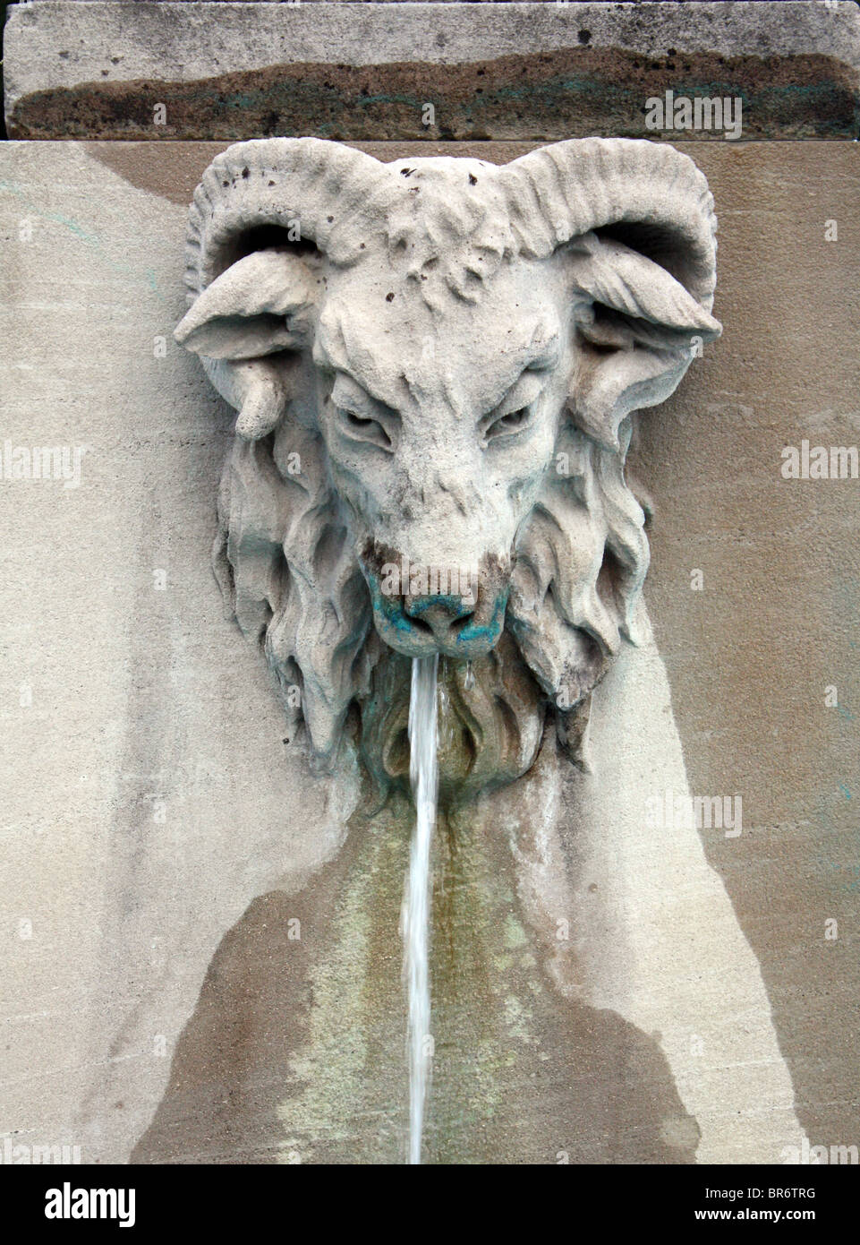 Ram-head stone carving as fountain Stock Photo - Alamy