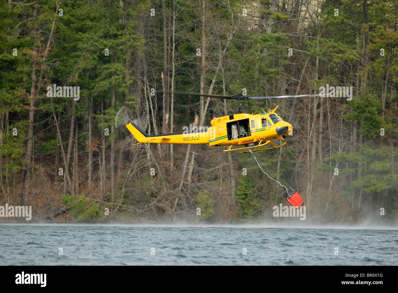 NC Forestry Service helicopter dips its bucket into Lake Julian while ...