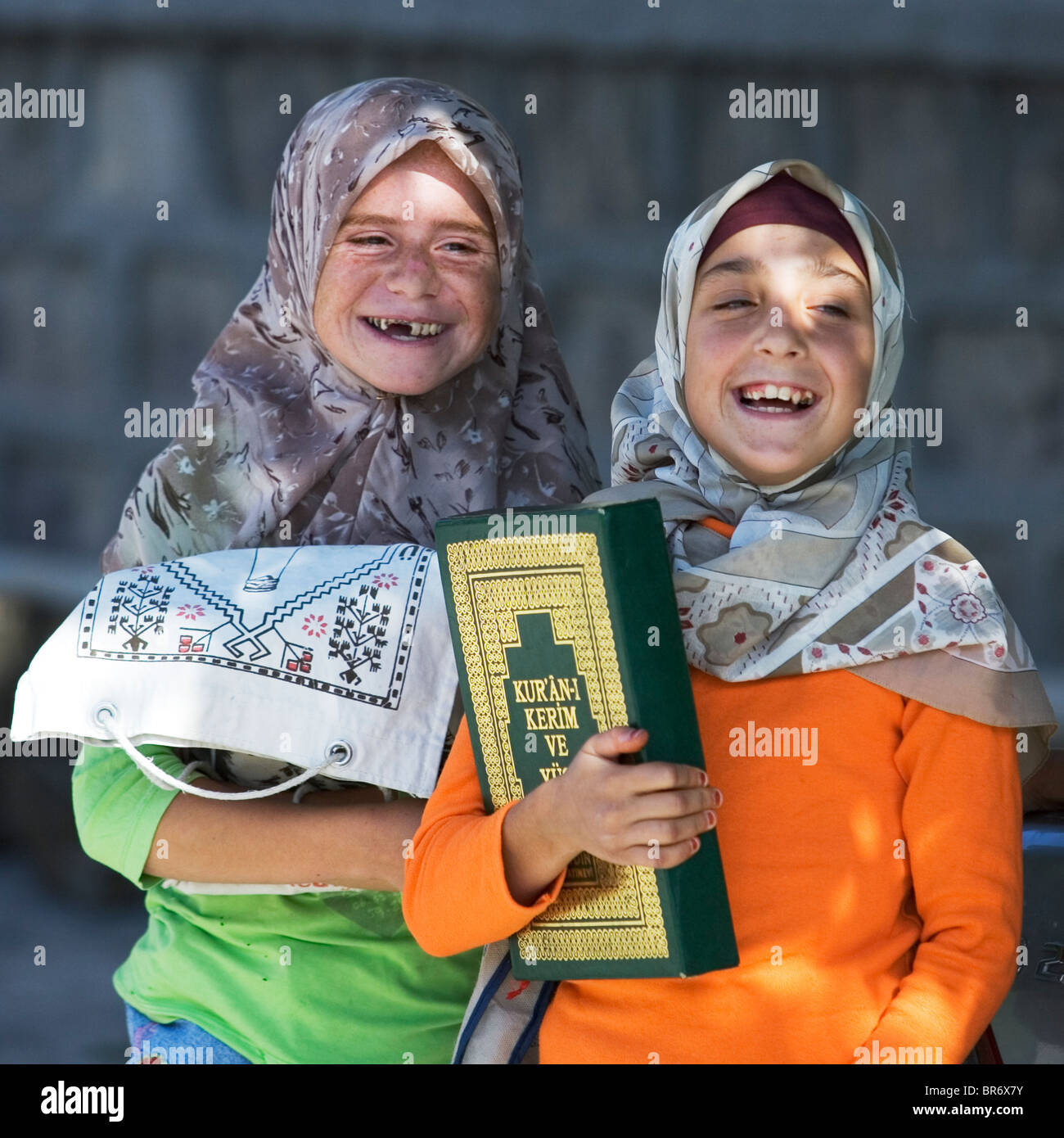 Two young girls in Urgup Turkey laugh at a friends joke Stock Photo - Alamy