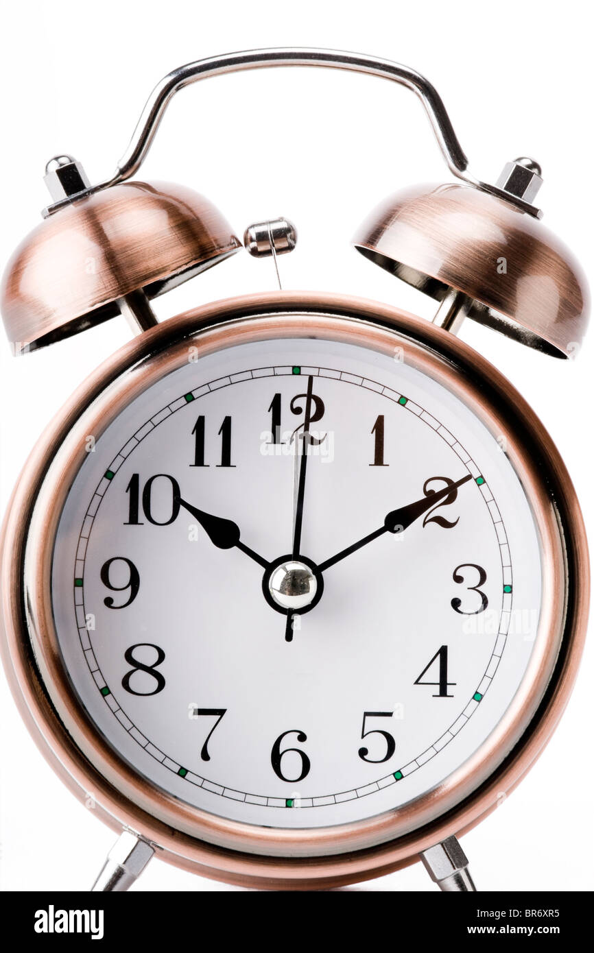 Copper alarm clock with bells on white background Stock Photo - Alamy