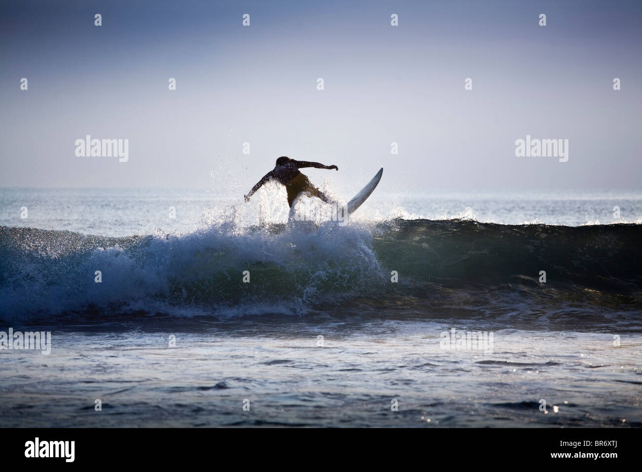 A Young man surfing a 4ft wave Stock Photo - Alamy
