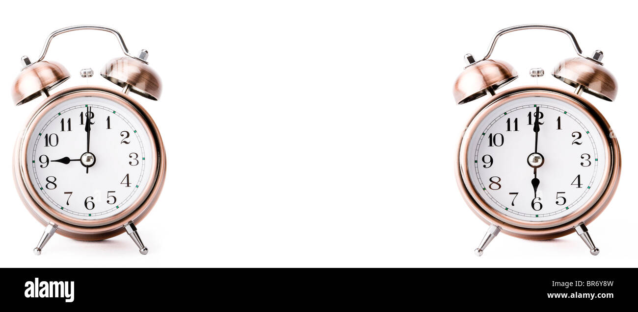 Copper alarm clock in office hours on white background Stock Photo - Alamy