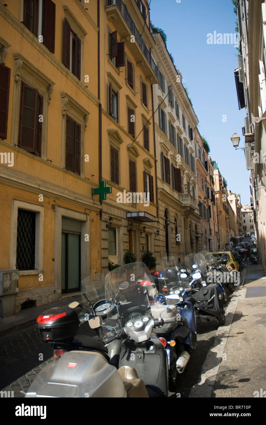 Motorcycles parked on a narrow street in Rome Italy Stock Photo - Alamy