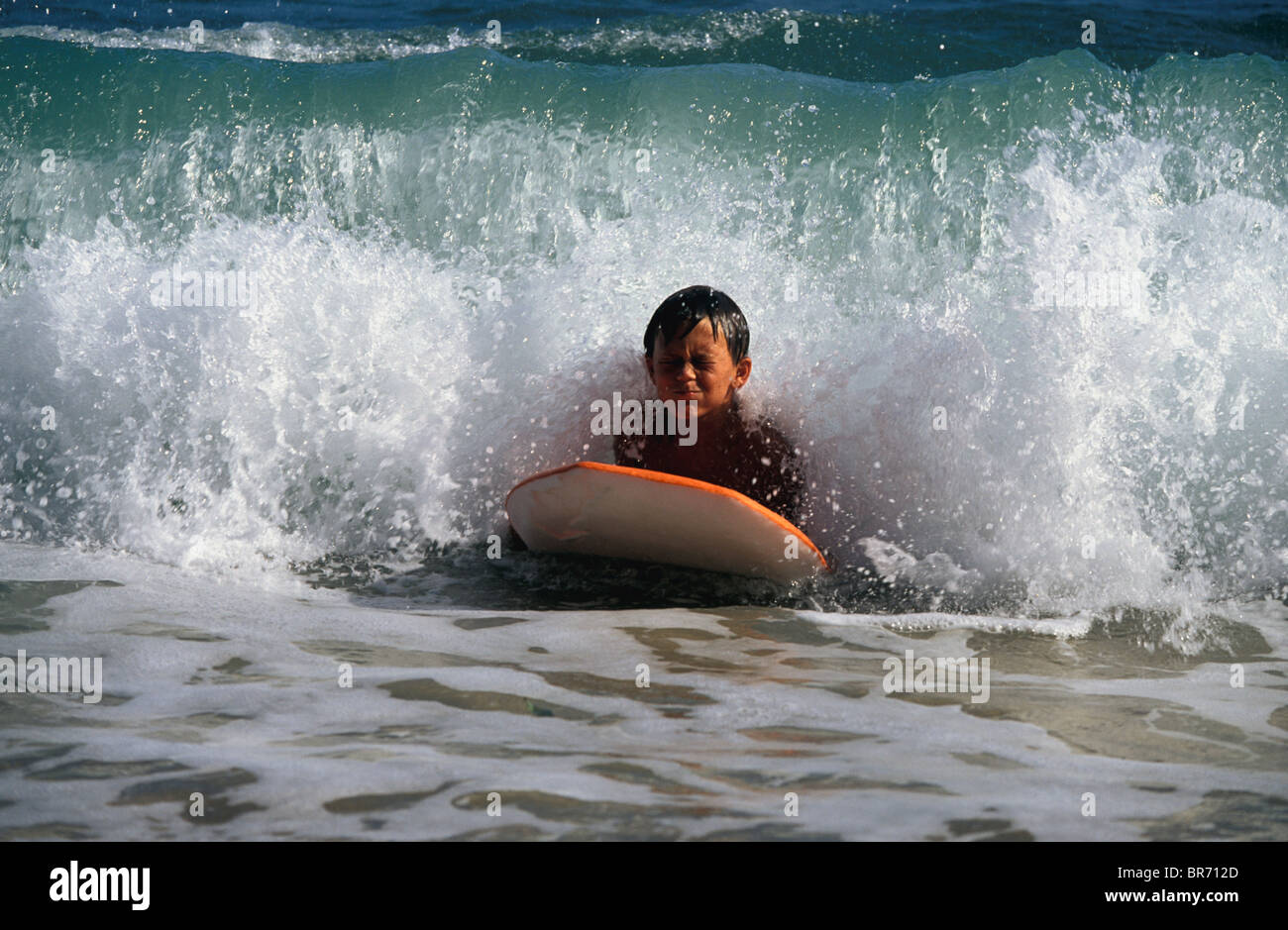 Young boy bodyboarding in the shallows off Diamond Head, Hawaii Stock ...