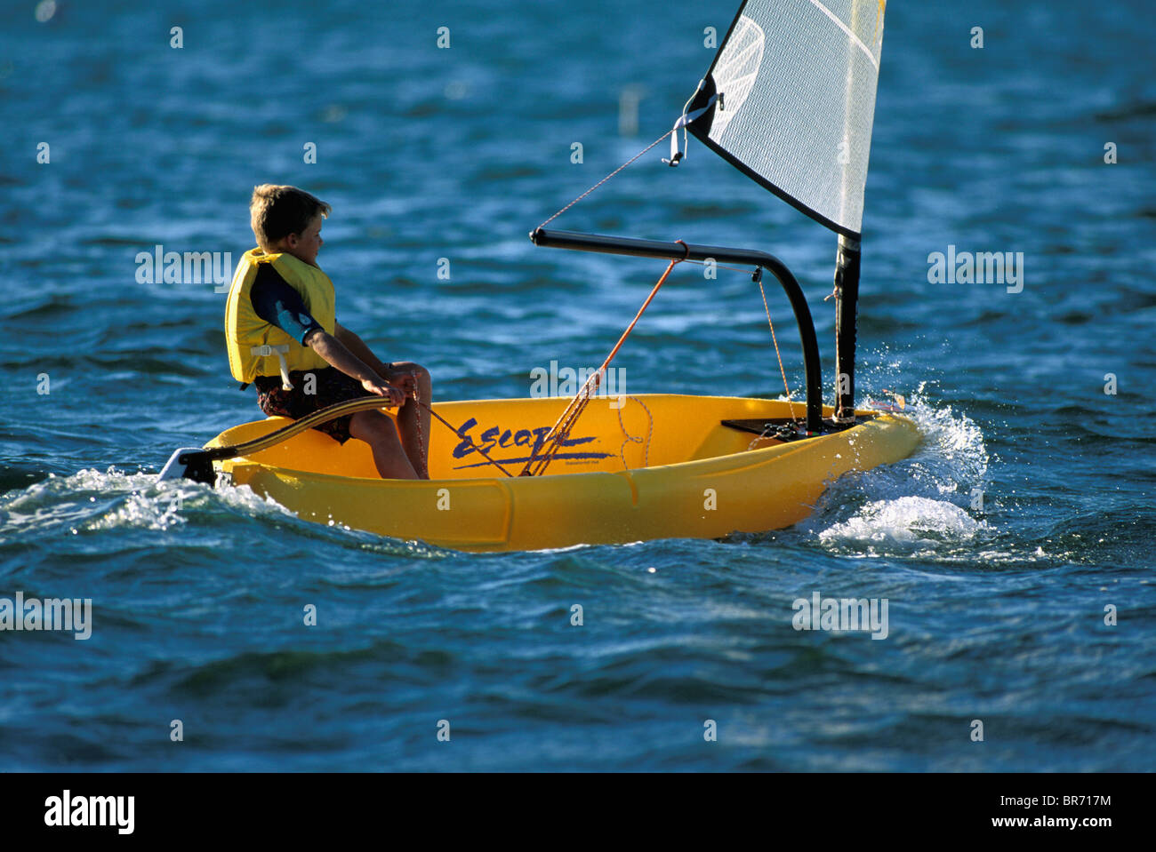 Young boy sailing an plastic roto moulded Escape dinghy Stock Photo - Alamy