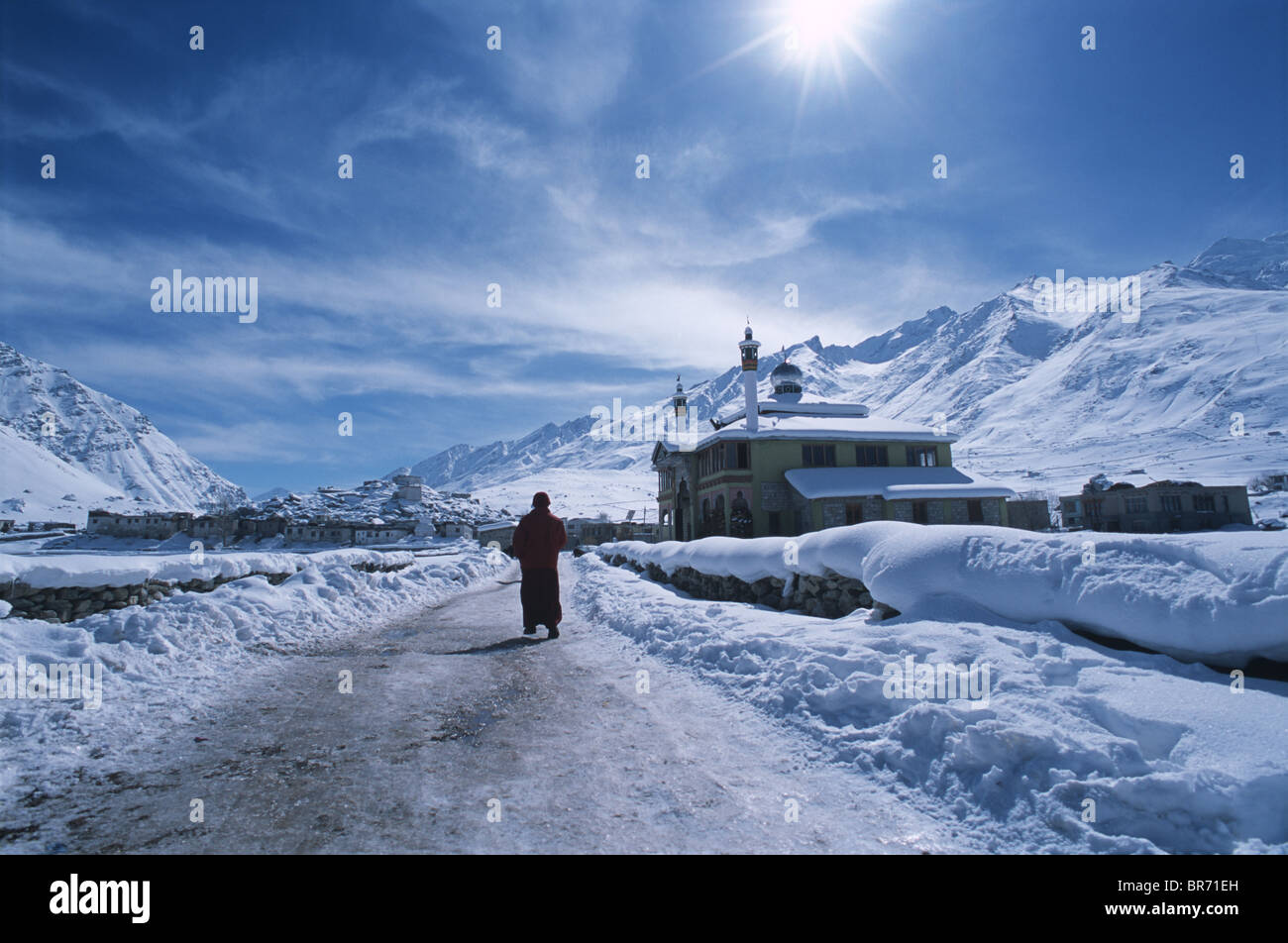 Buddhist monk walking by Muslim mosque on frozen road Stock Photo - Alamy