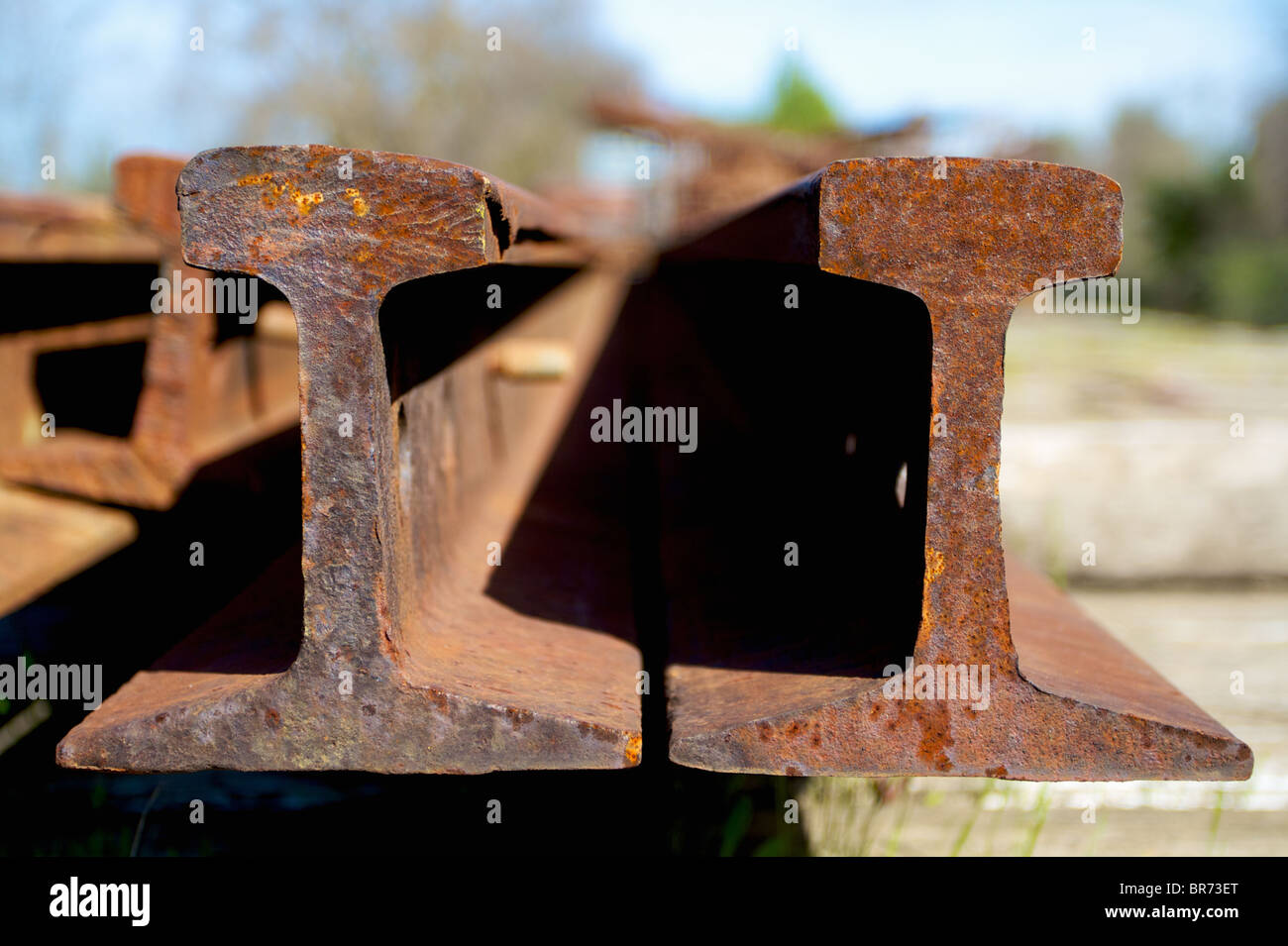 Two Rusted Railroad rail beams in full sun bringing out rich colors of ...