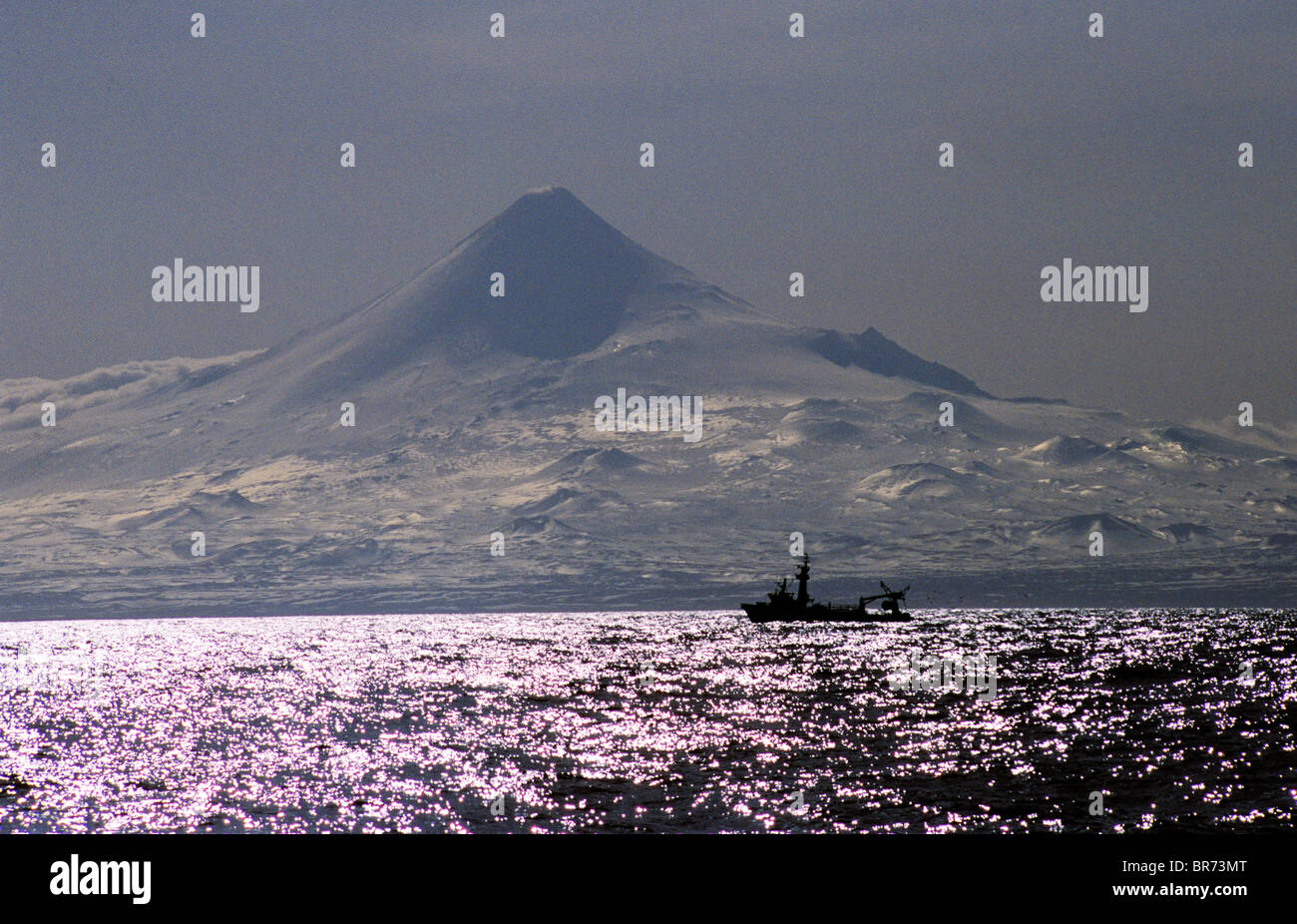 A fishing vessel travels past Mt. Shishaldin on Unimak Island in the ...