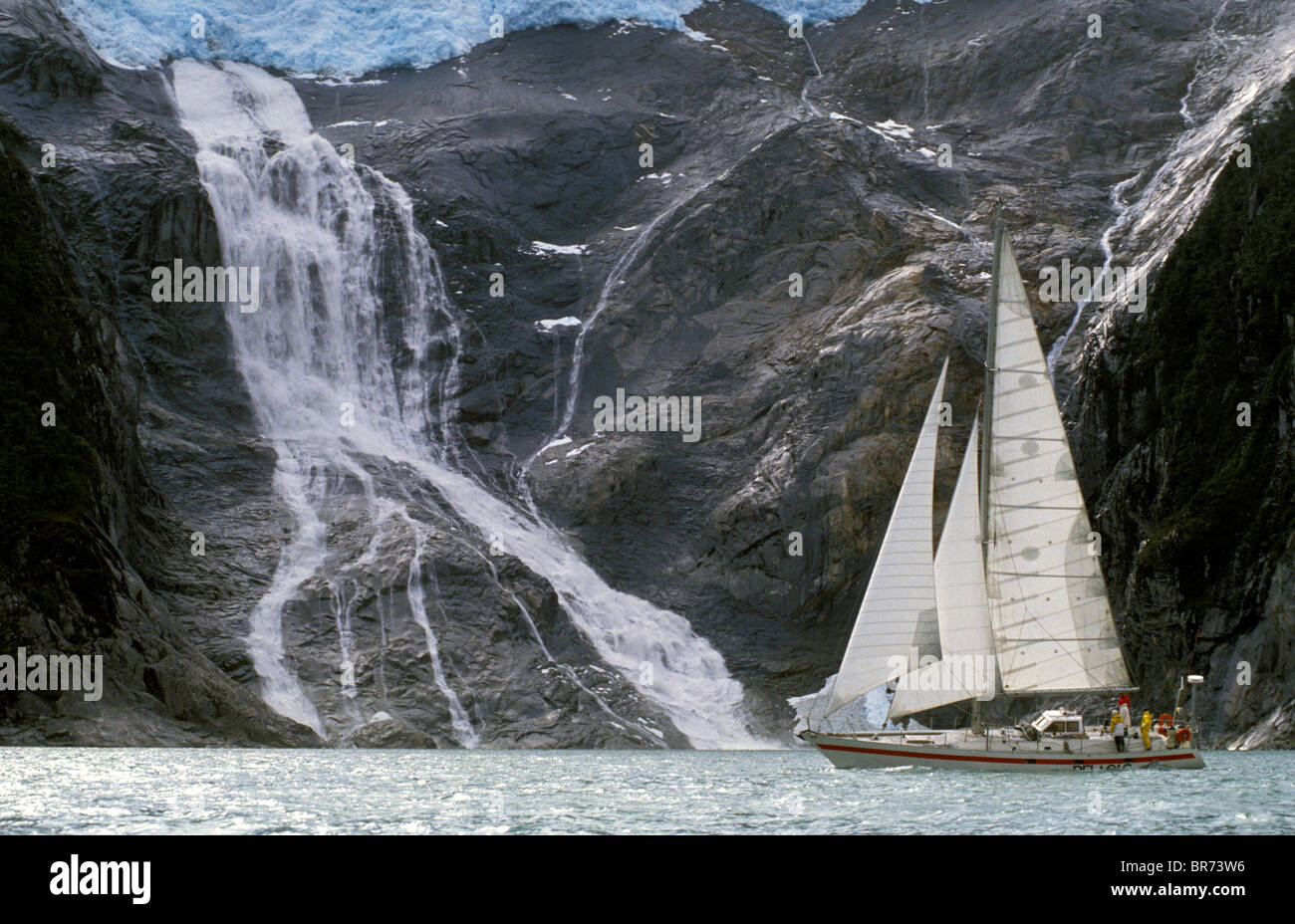 Skip Novak's yacht "Pelagic" passes beneath a glacial waterfall in ...
