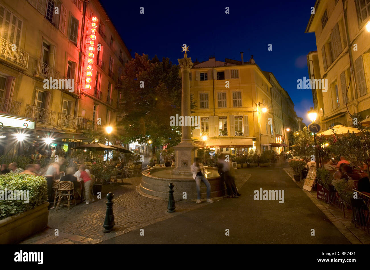Night city scene in Aix-En-Provence France with restaurants and people ...