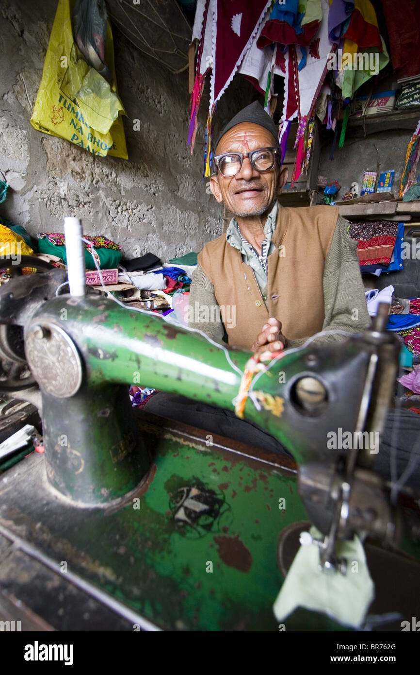 Man sewing goods in small village India Stock Photo - Alamy