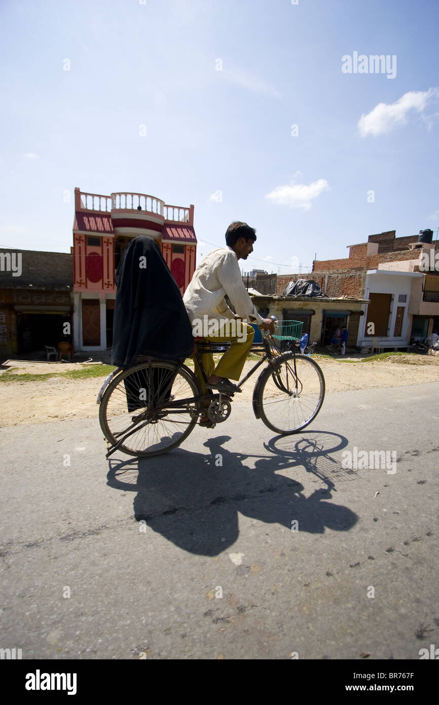 Local couple riding bike India Stock Photo - Alamy