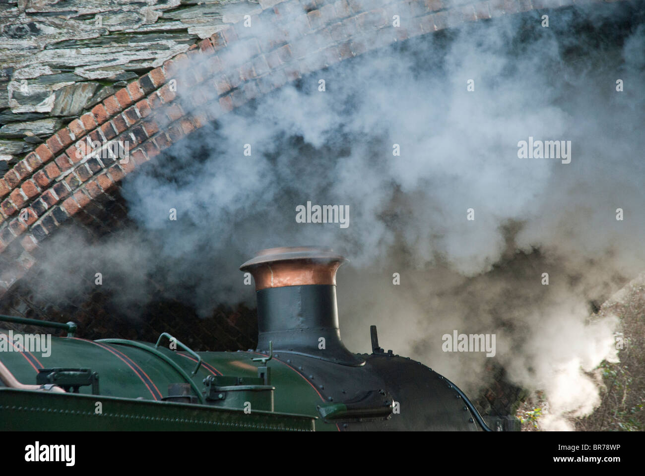 Steam locomotive going under bridge on the Llangollen railway Stock ...