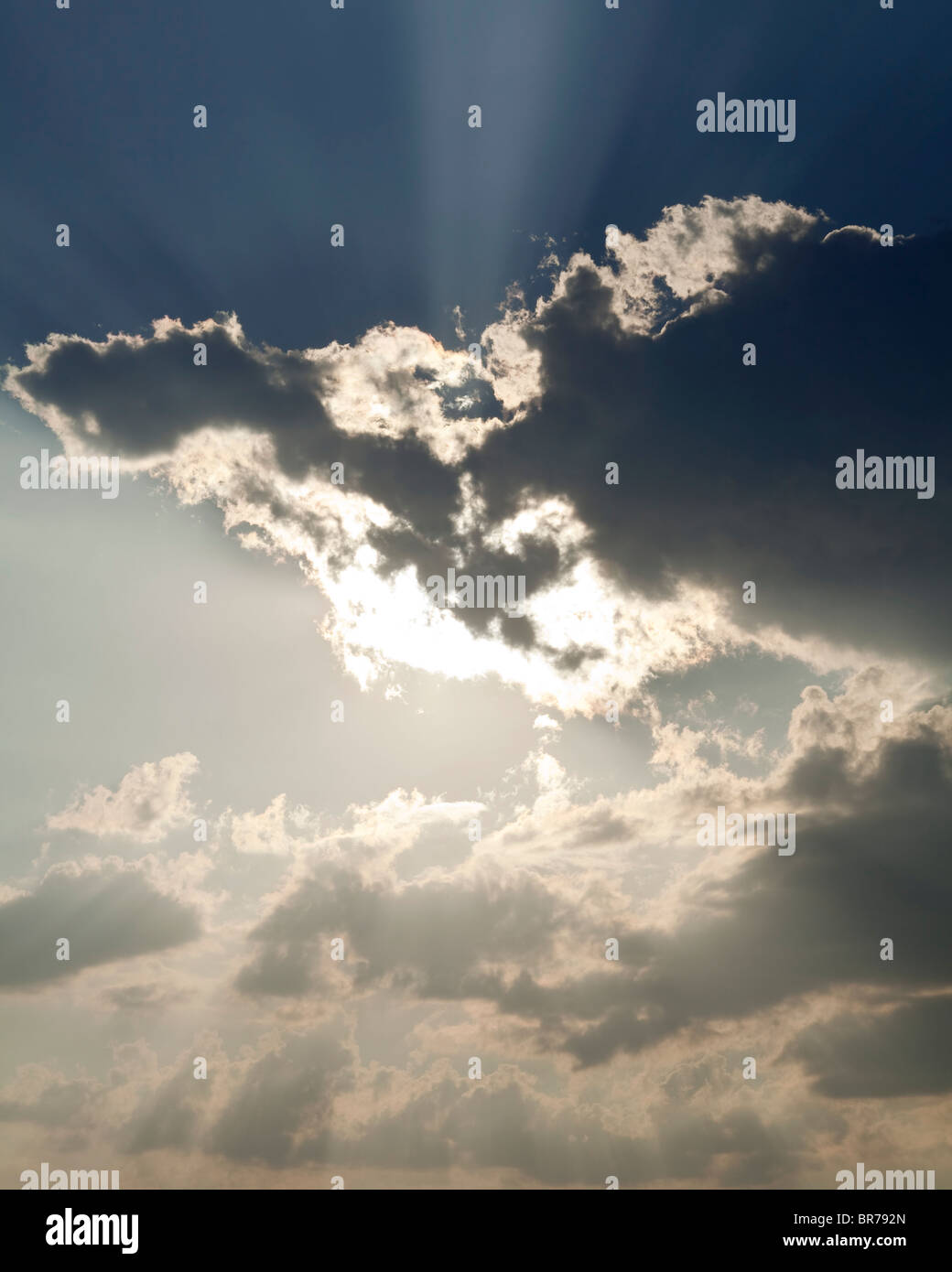 Sun rays breaking thru the clouds Stock Photo - Alamy